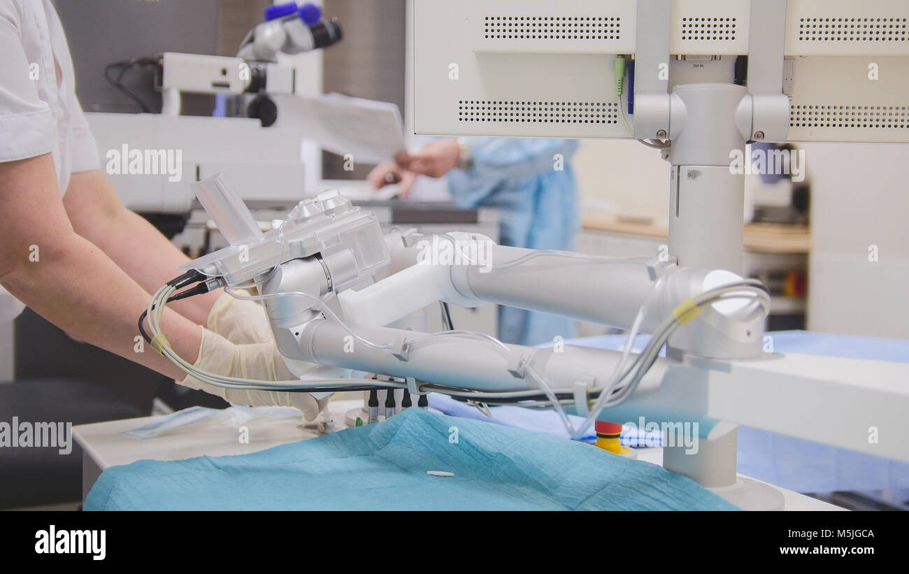 Surgeons and anesthesiologist prepare for surgery in an operating room ...