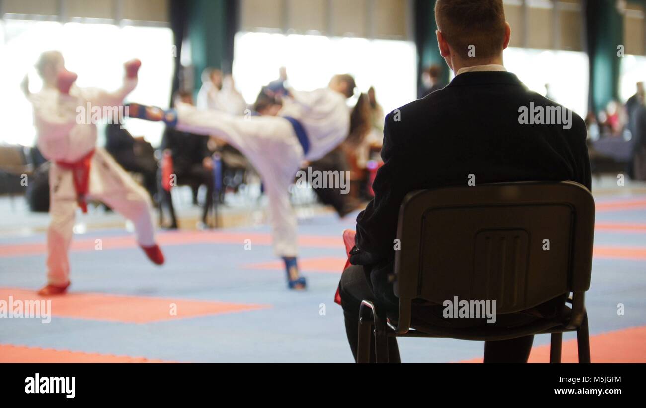 Martial art competitions- karate - judge coaches looking at female ...
