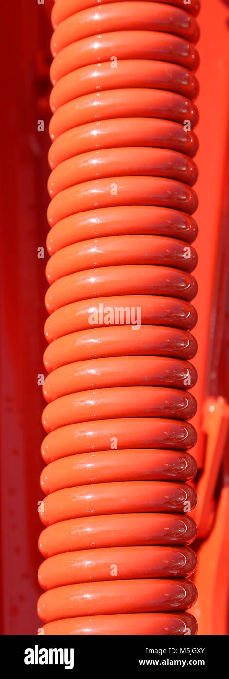 very long huge red industrial spring of a car Stock Photo - Alamy