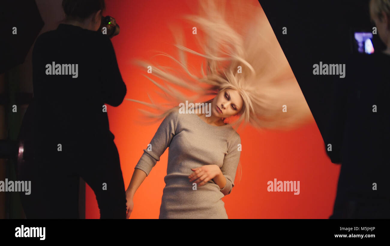 Flowing hair of attractive model girl in photo studio, slow-motion ...