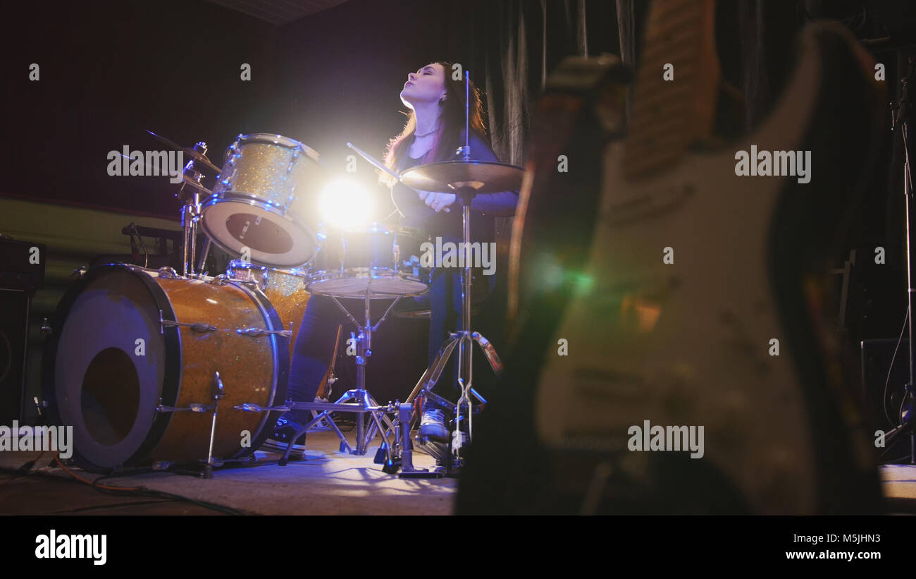 Young female with black hair percussion drummer performing with drums ...