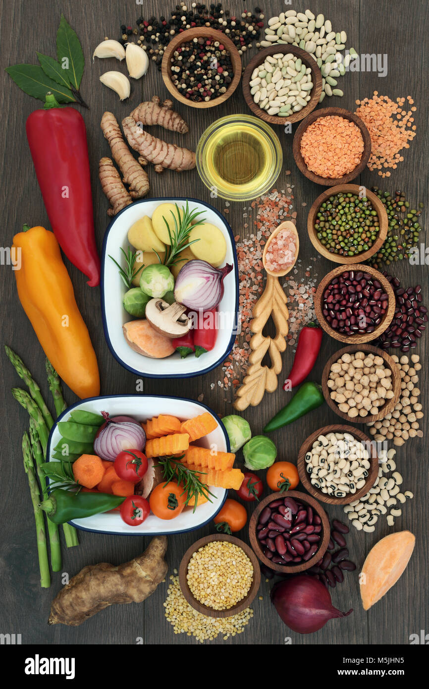 Healthy food concept with fresh vegetables, herbs, spices, dried pulses ...