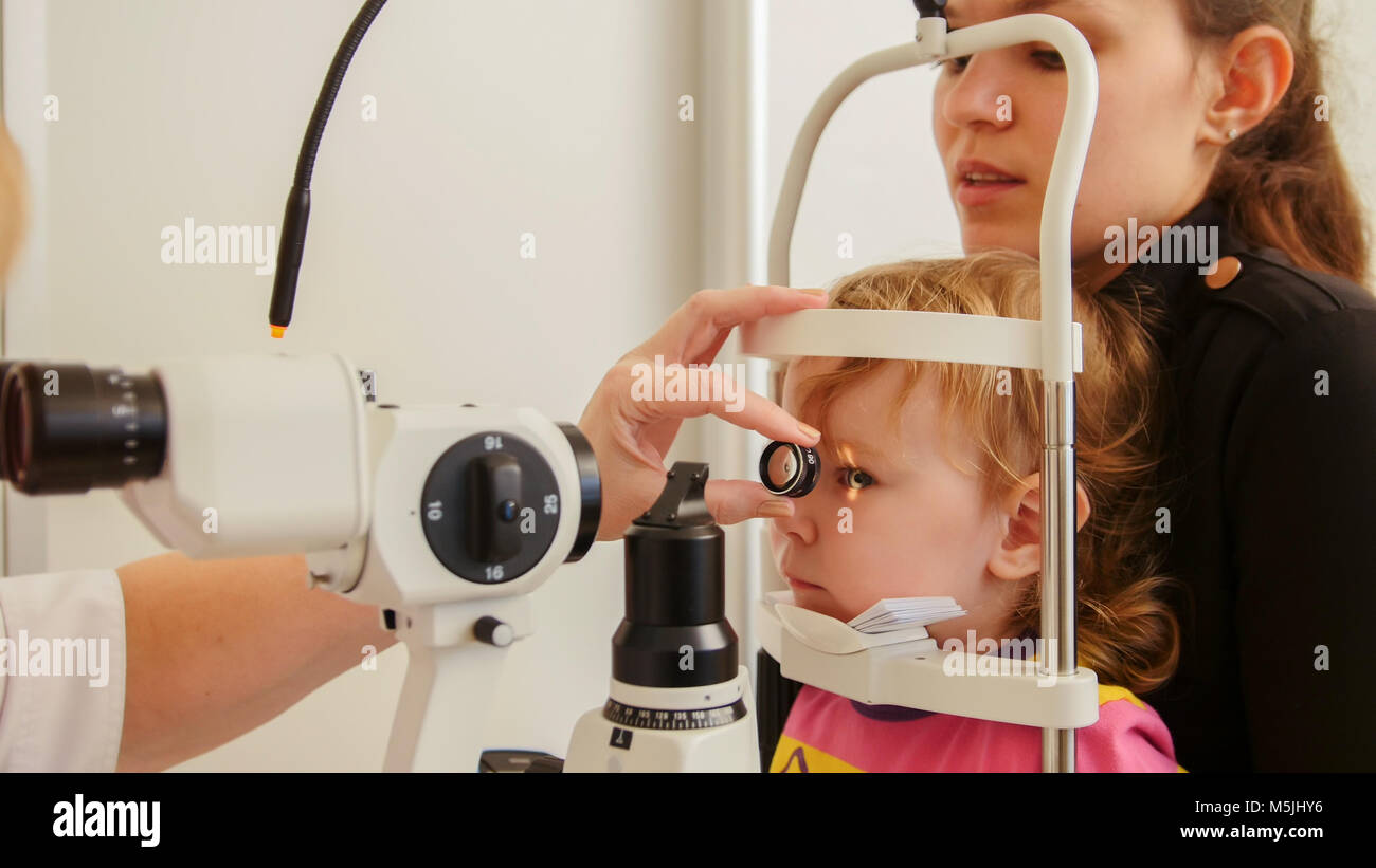 Child's ophthalmology - doctor optometrist checks eyesight for patient ...