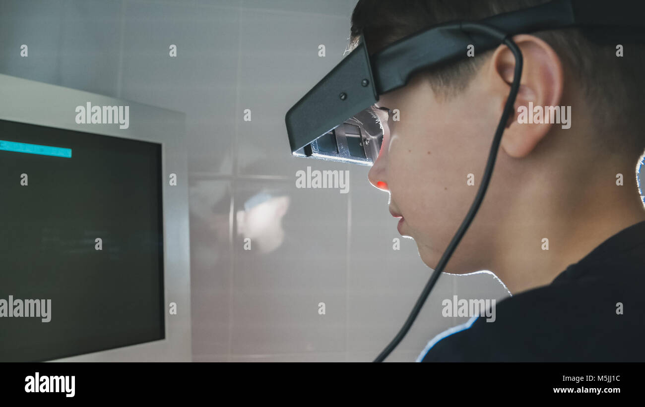 Ophthalmology - child boy checks eyes with stereo glasses and monitor ...