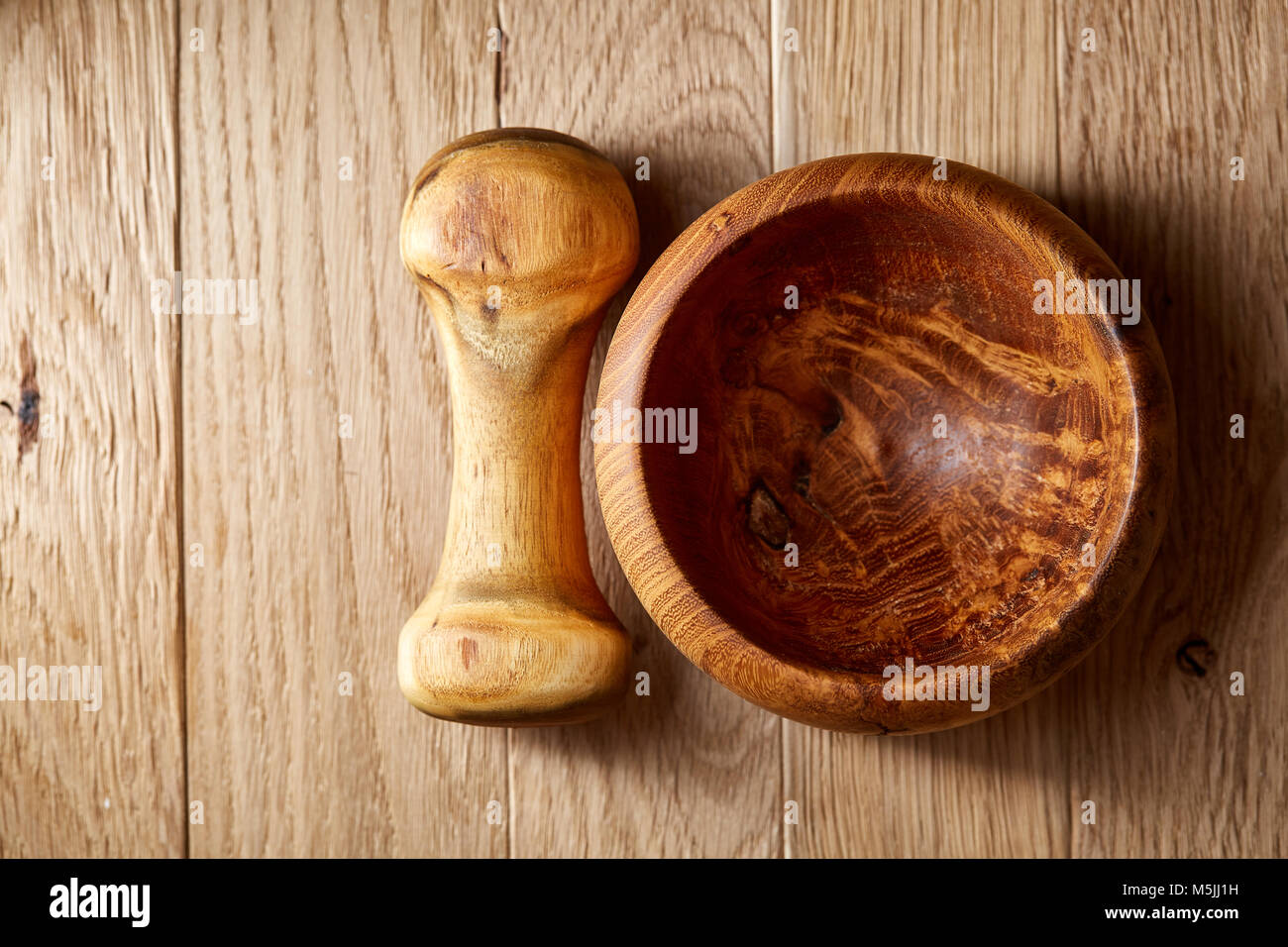 Composition of wooden pestle and mortar arranged on rustic brown wooden ...