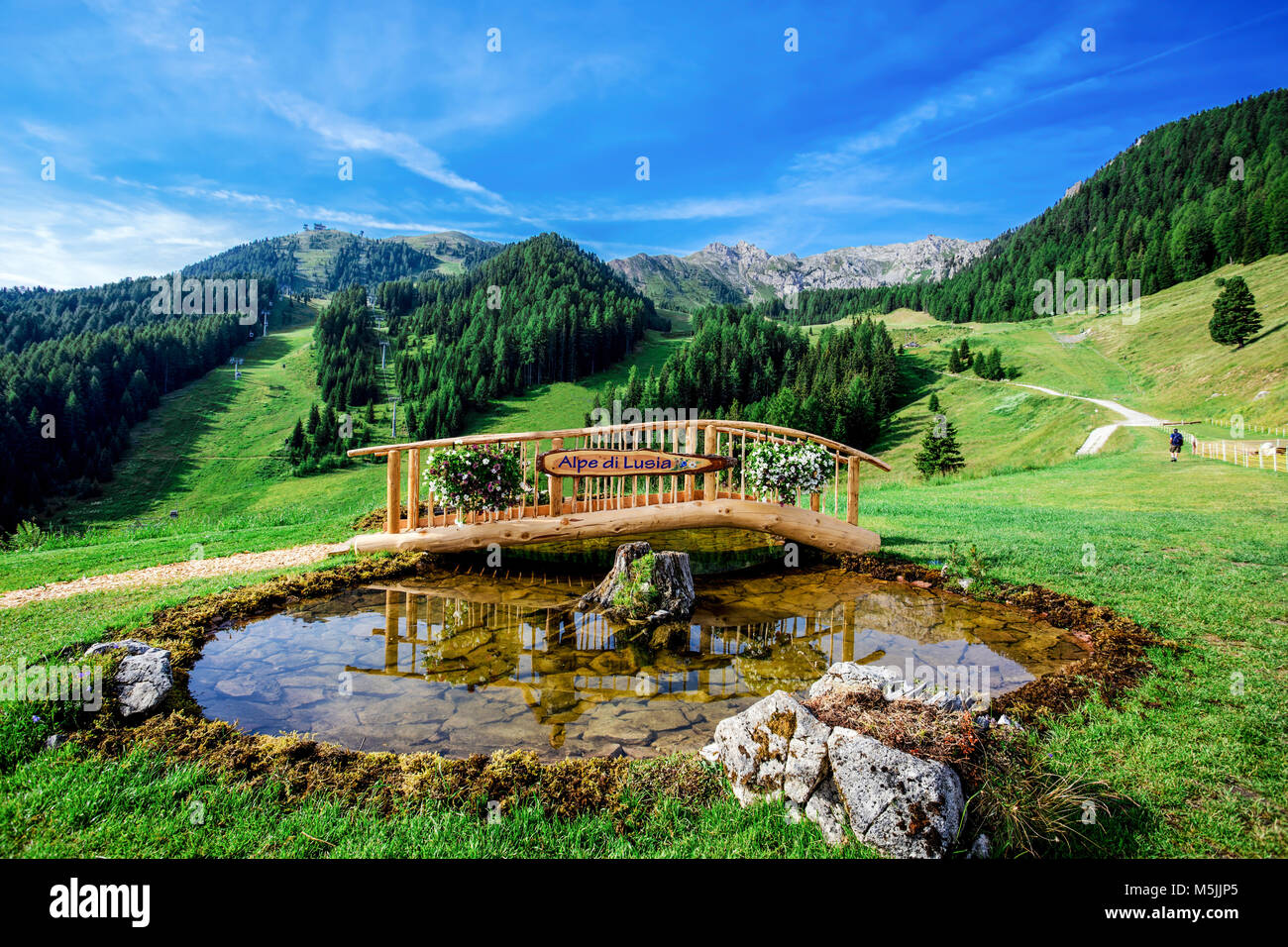 Small wooden bridge with a pond in a beautiful mountainous dolomites ...