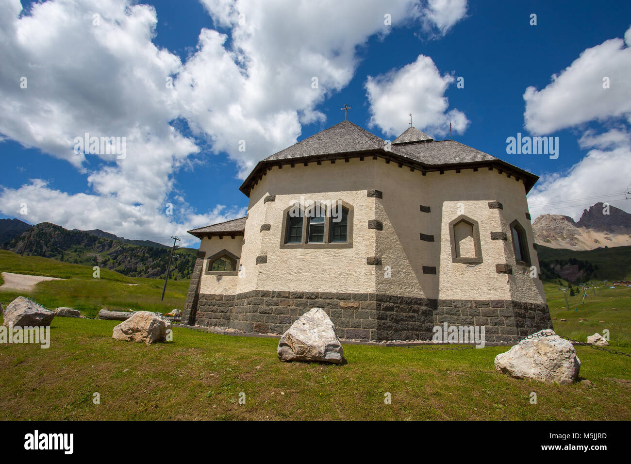 Beautiful mountain church under a sunny blue sky with clouds/Trentino ...