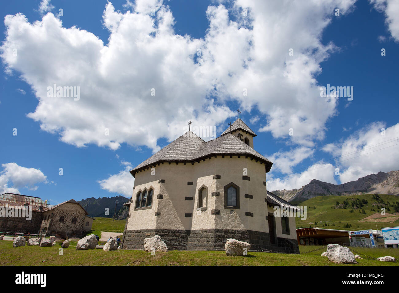 Beautiful mountain church under a sunny blue sky with clouds/Trentino ...