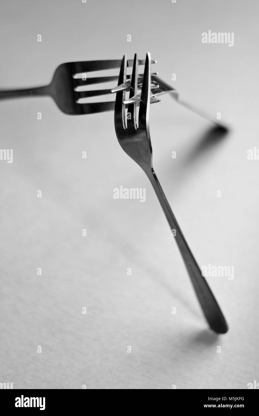 Intertwined three forks Stock Photo - Alamy