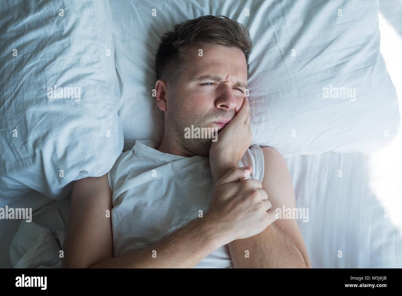 Touching cheek in bed hi-res stock photography and images - Alamy