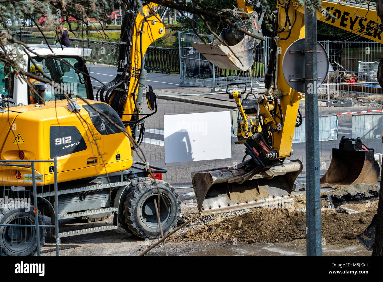 Civil engineering, mechanical shovel digging service trench, water pipe ...