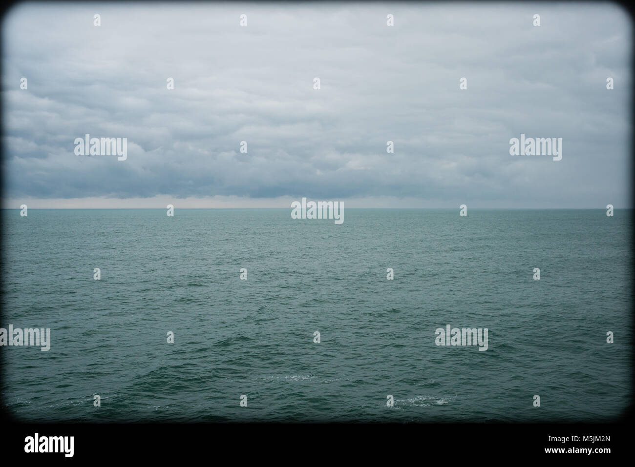 Empty open sea ocean in cold grey colours with vintage matte effect and ...