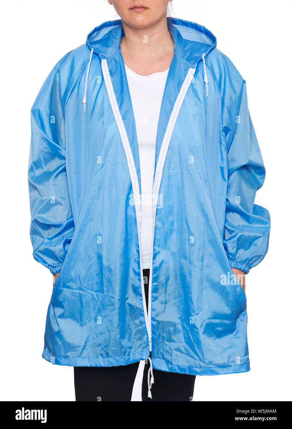 Young woman is wearing blue raincoat with hood isolated on white ...