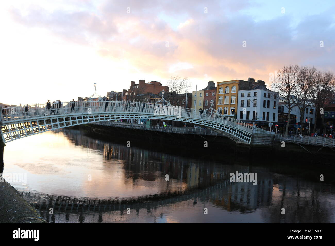 Dublin night scene with Ha'penny bridge and Liffey river lights ...