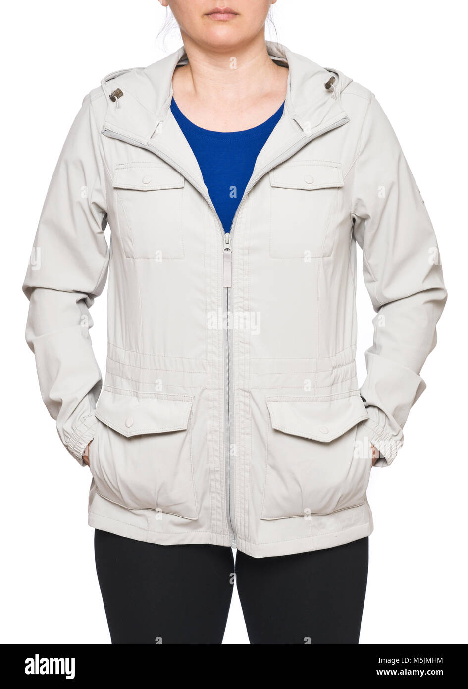 Young woman wearing beige rain jacket isolated on white background ...