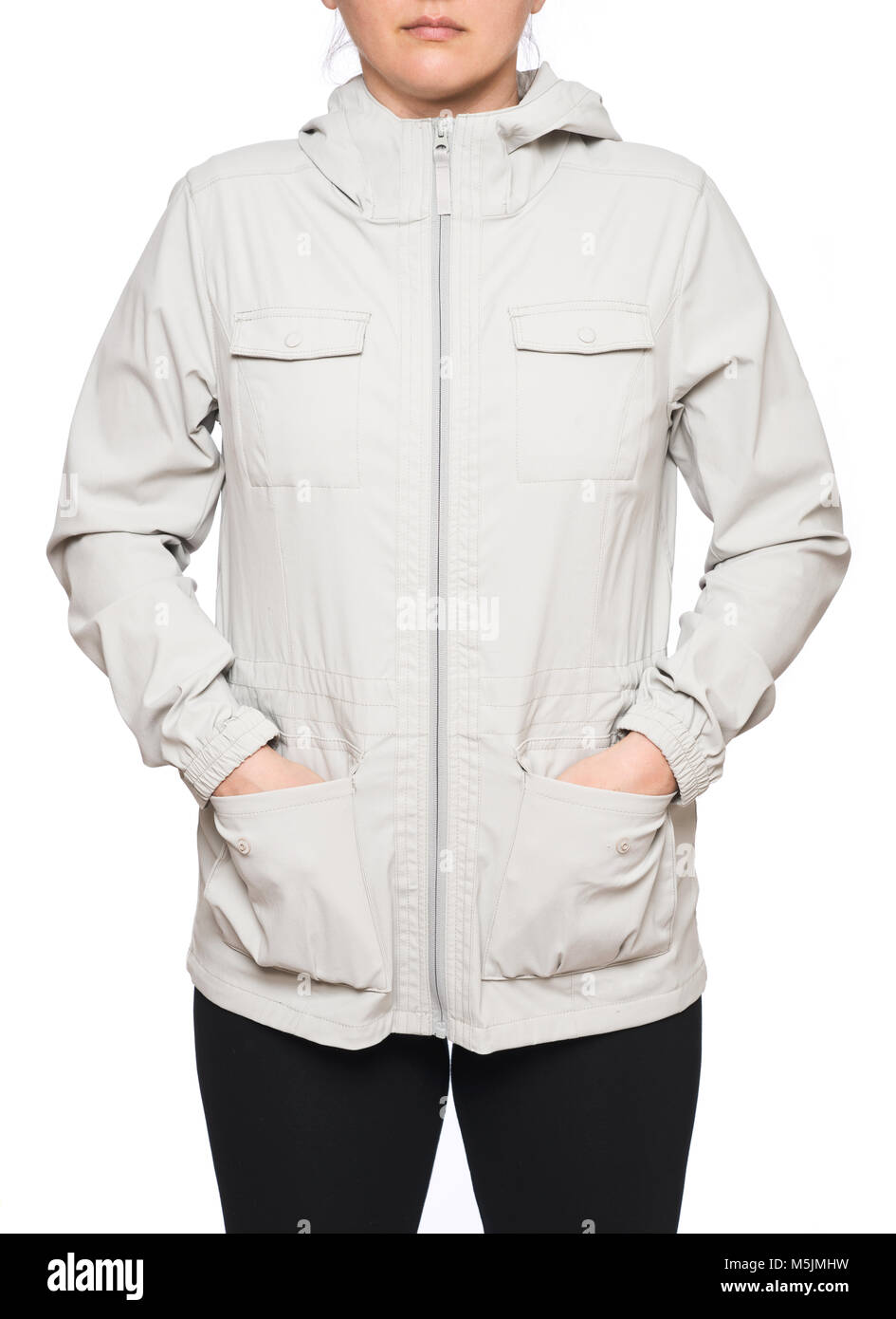 Young woman wearing beige rain jacket isolated on white background ...