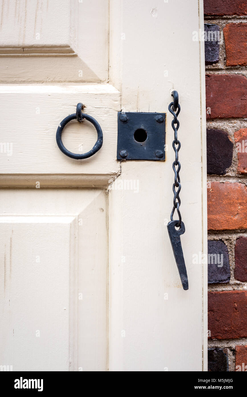 Metal black keyhole on a white painted door handing on a chain Stock ...