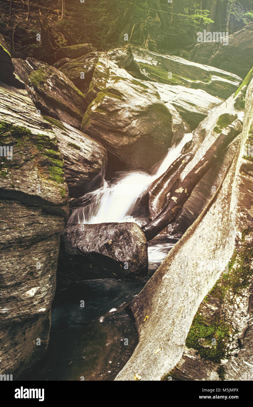 Small waterfall in between rocks Stock Photo - Alamy