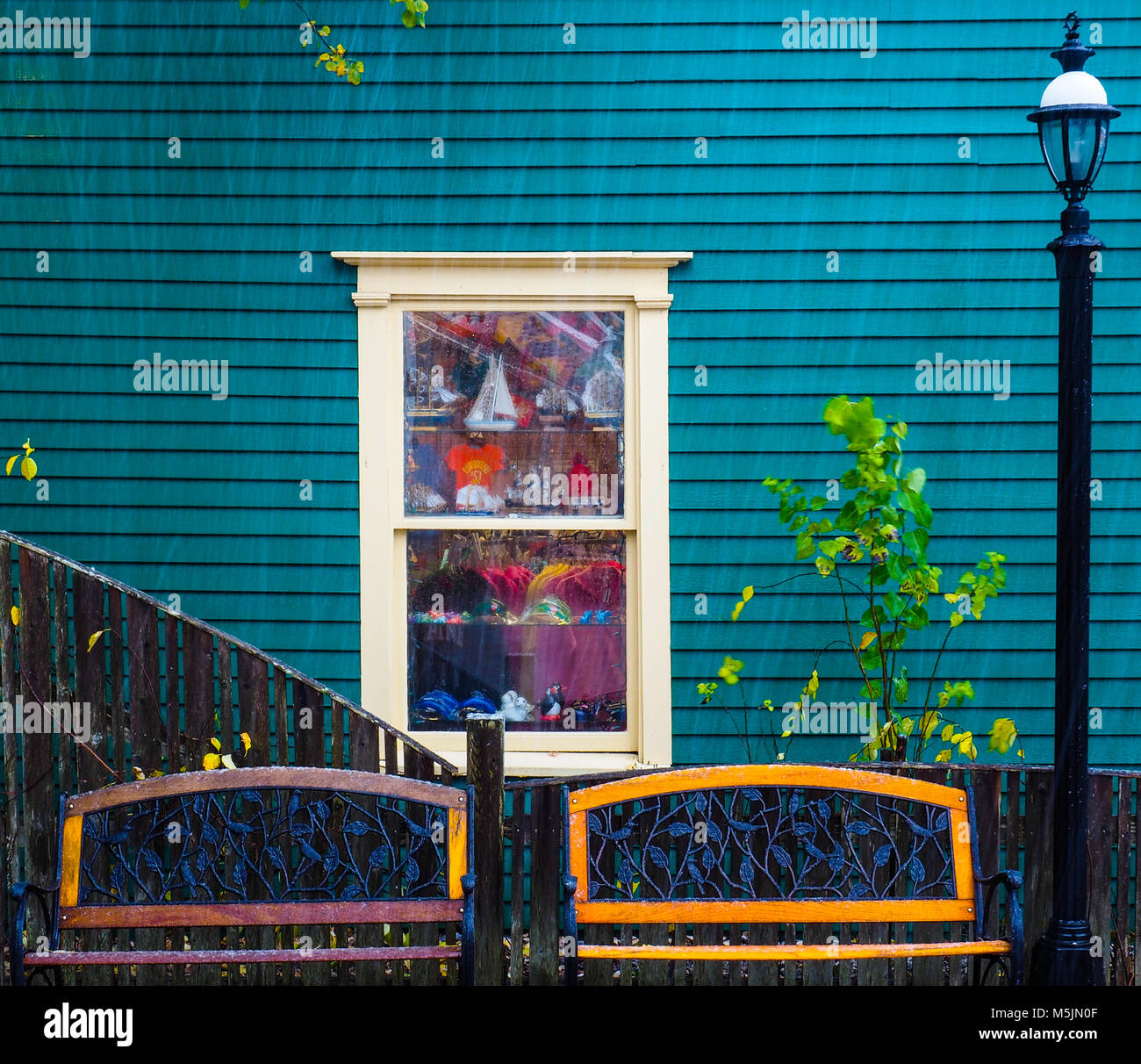 Two benches and a lamp post outside a shop in the snow Stock Photo - Alamy