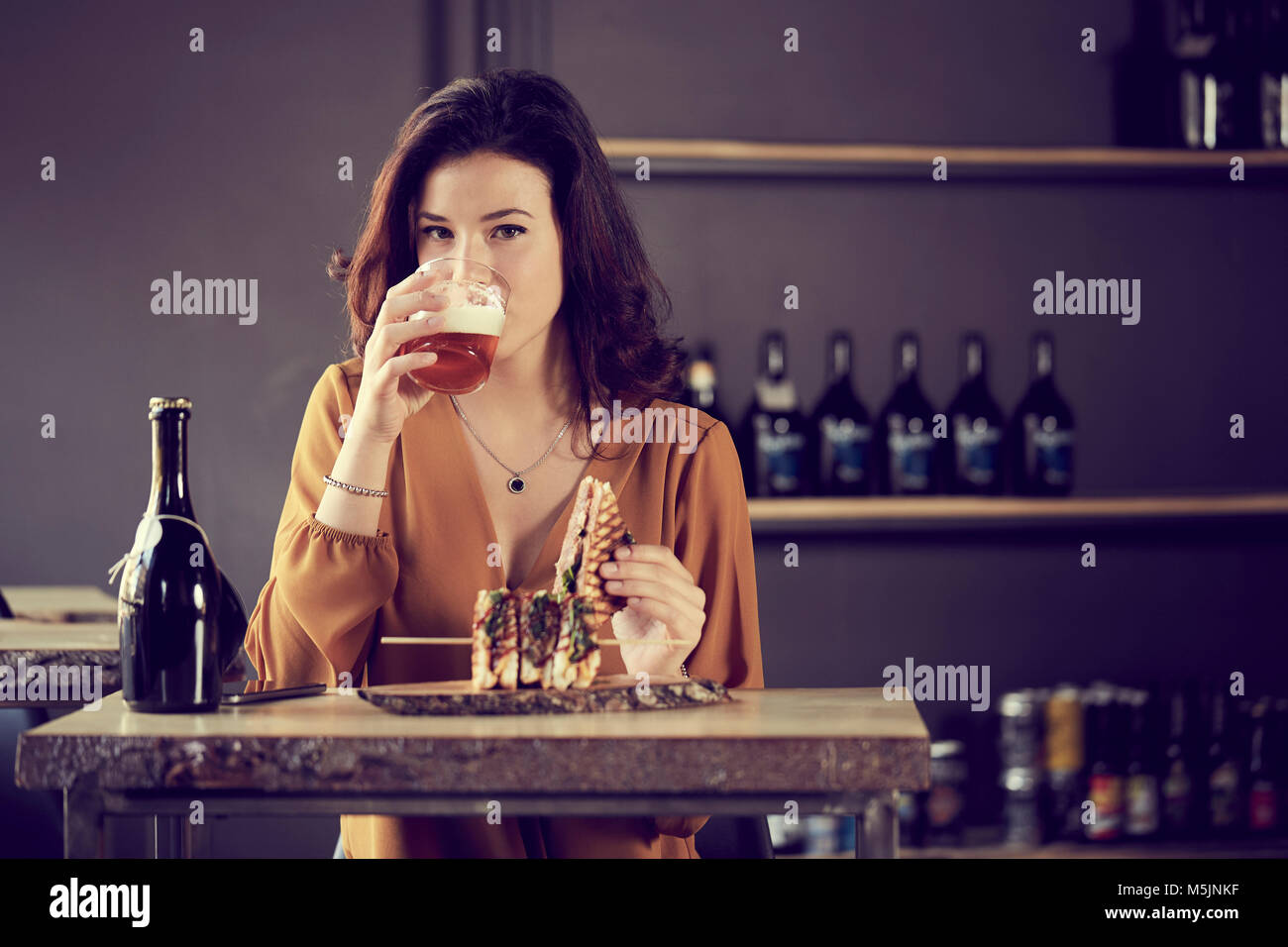 pretty woman eating a club sandwich Stock Photo - Alamy