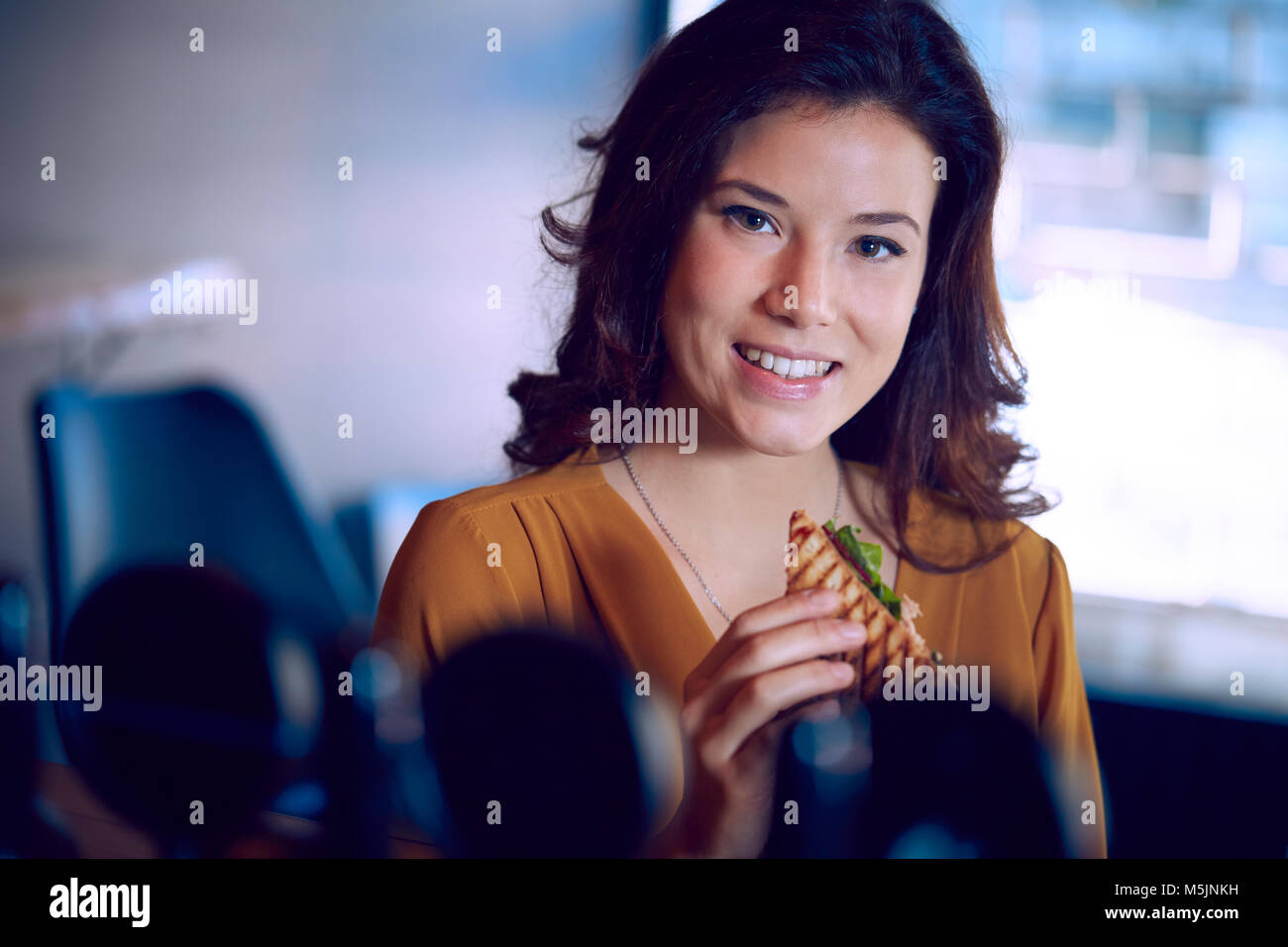 pretty woman eating a club sandwich Stock Photo - Alamy