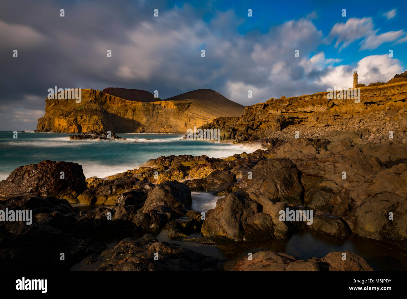 Rocky coast with lighthouse Farol da Ponta dos Capelinhos,Capelinhos ...