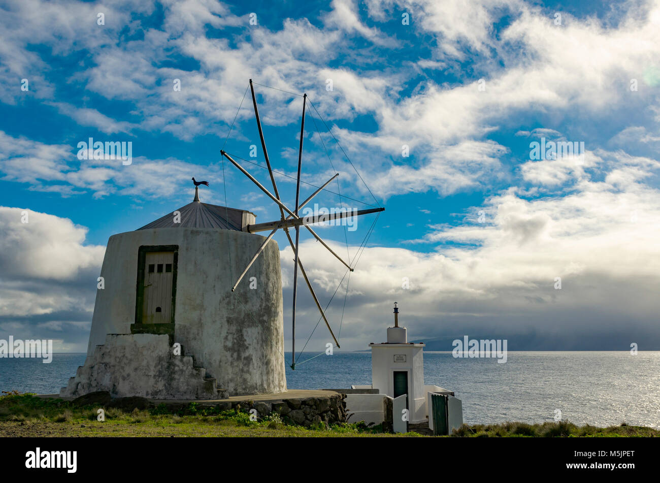 White windmill at the sea in front of a cloudy sky,Vila do Corvo,Corvo ...