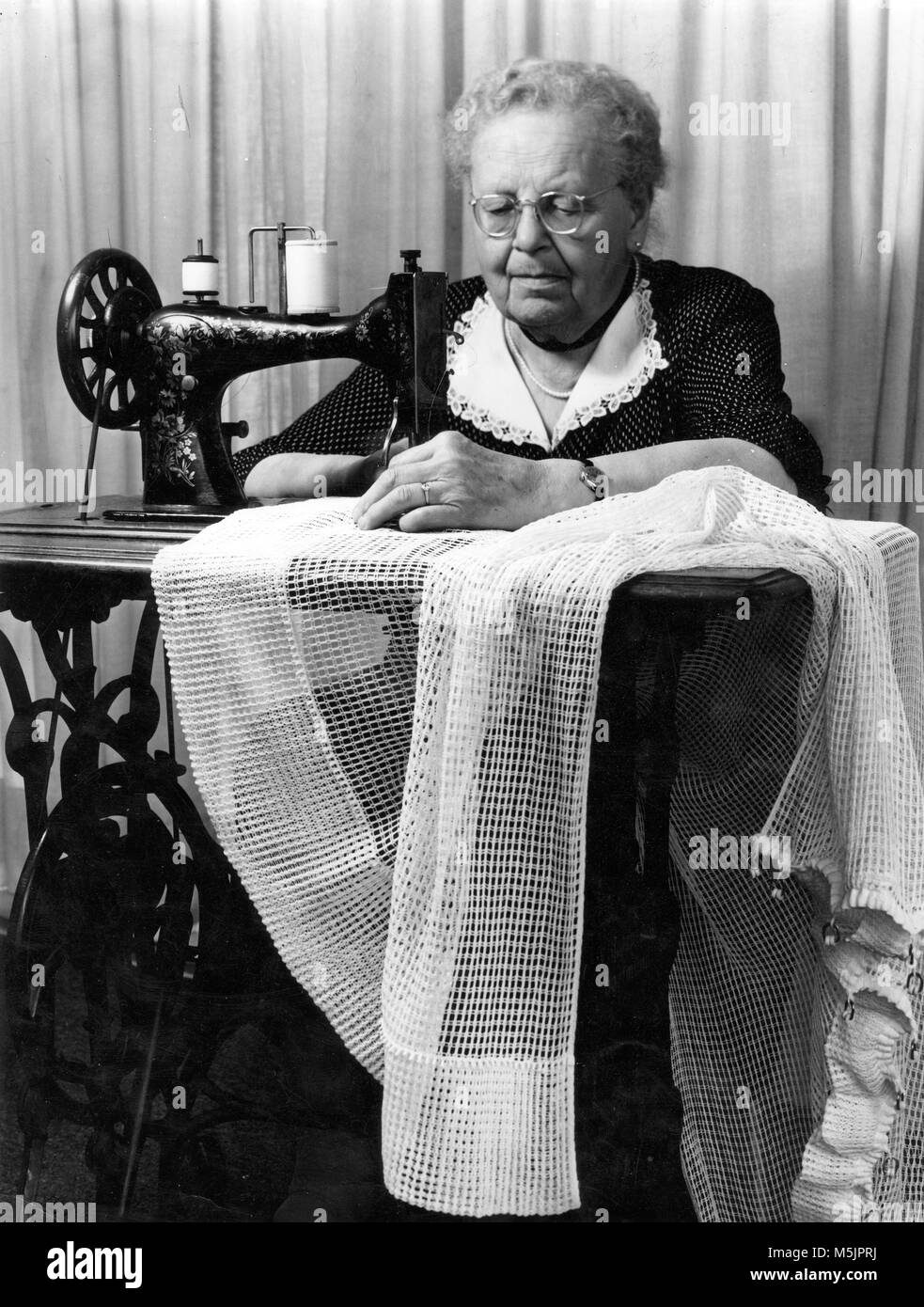 Old woman sewing Black and White Stock Photos & Images - Alamy