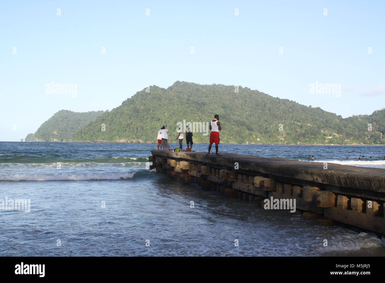 Men Fishing On Jetty Stock Photo - Alamy