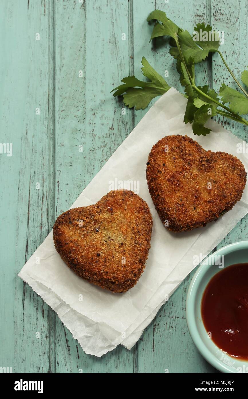 Homemade heart shaped Lamb meat cutlets / Valentines day food overhead ...