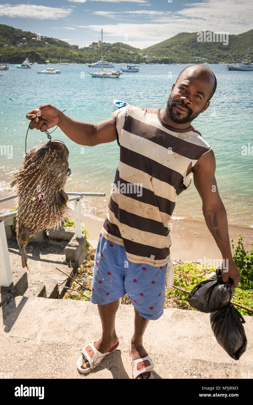 Man holding fish caribbean hi-res stock photography and images - Alamy