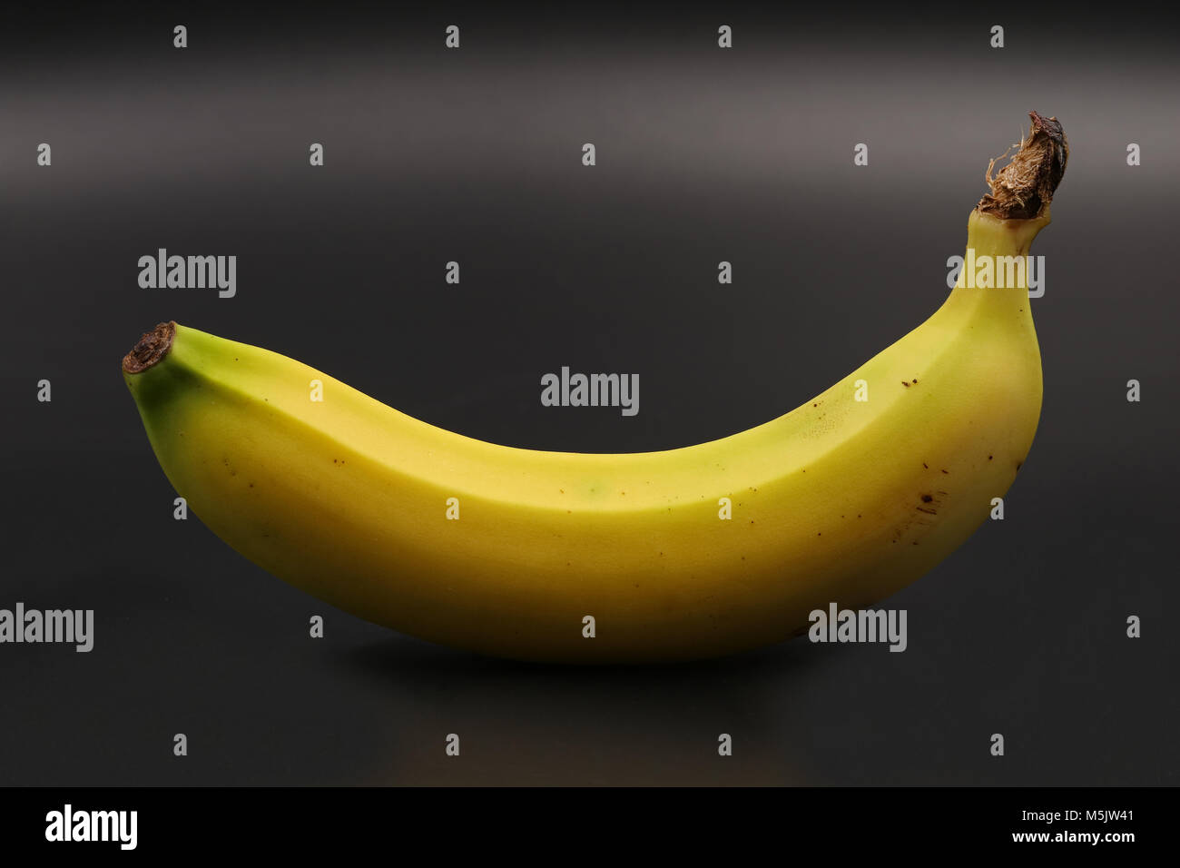 single banana sideview close-up isolated on black Stock Photo - Alamy