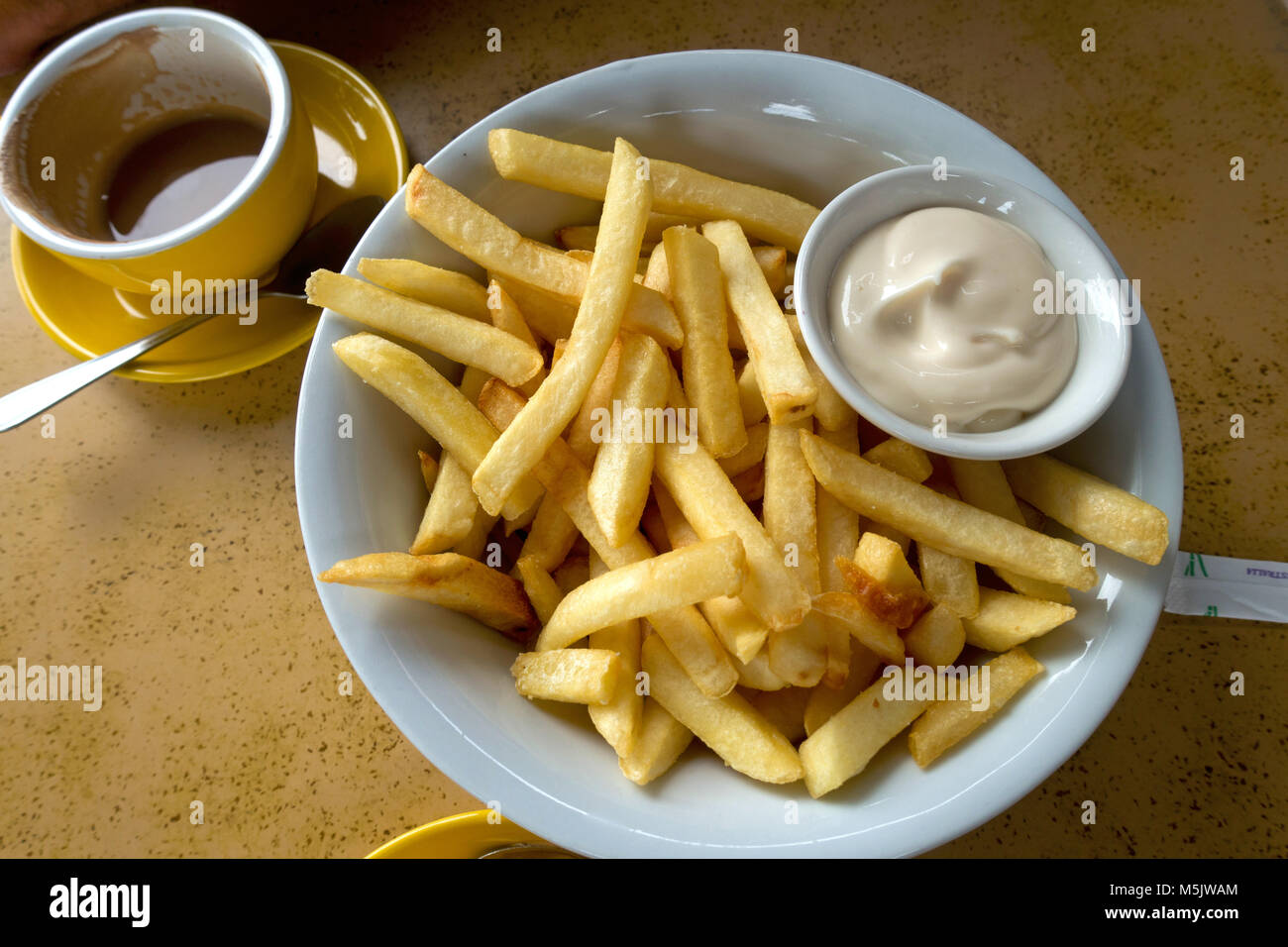 Hot Aussie Chips. Crunchy Golden goodness with a side of tangy mayo Stock Photo - Alamy