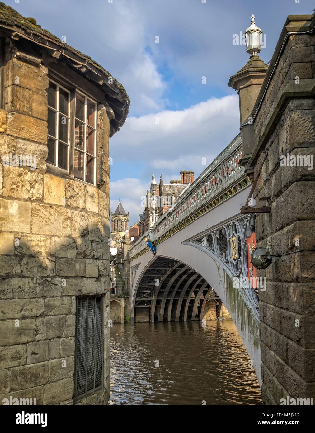 A tight perspective of Lendal Bridge with an historic building and the ...