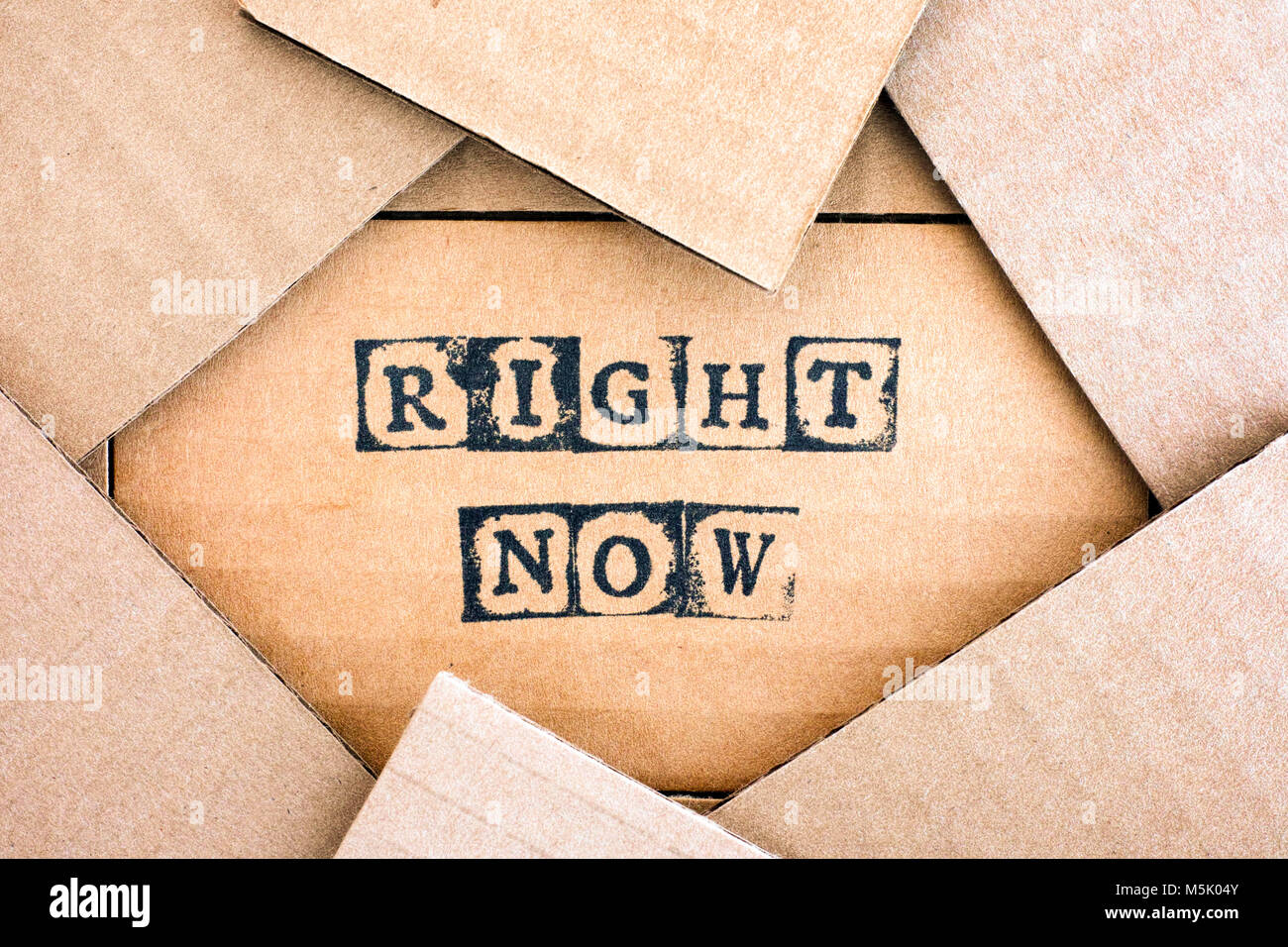 Words Right Now make by black alphabet stamps on cardboard with some ...