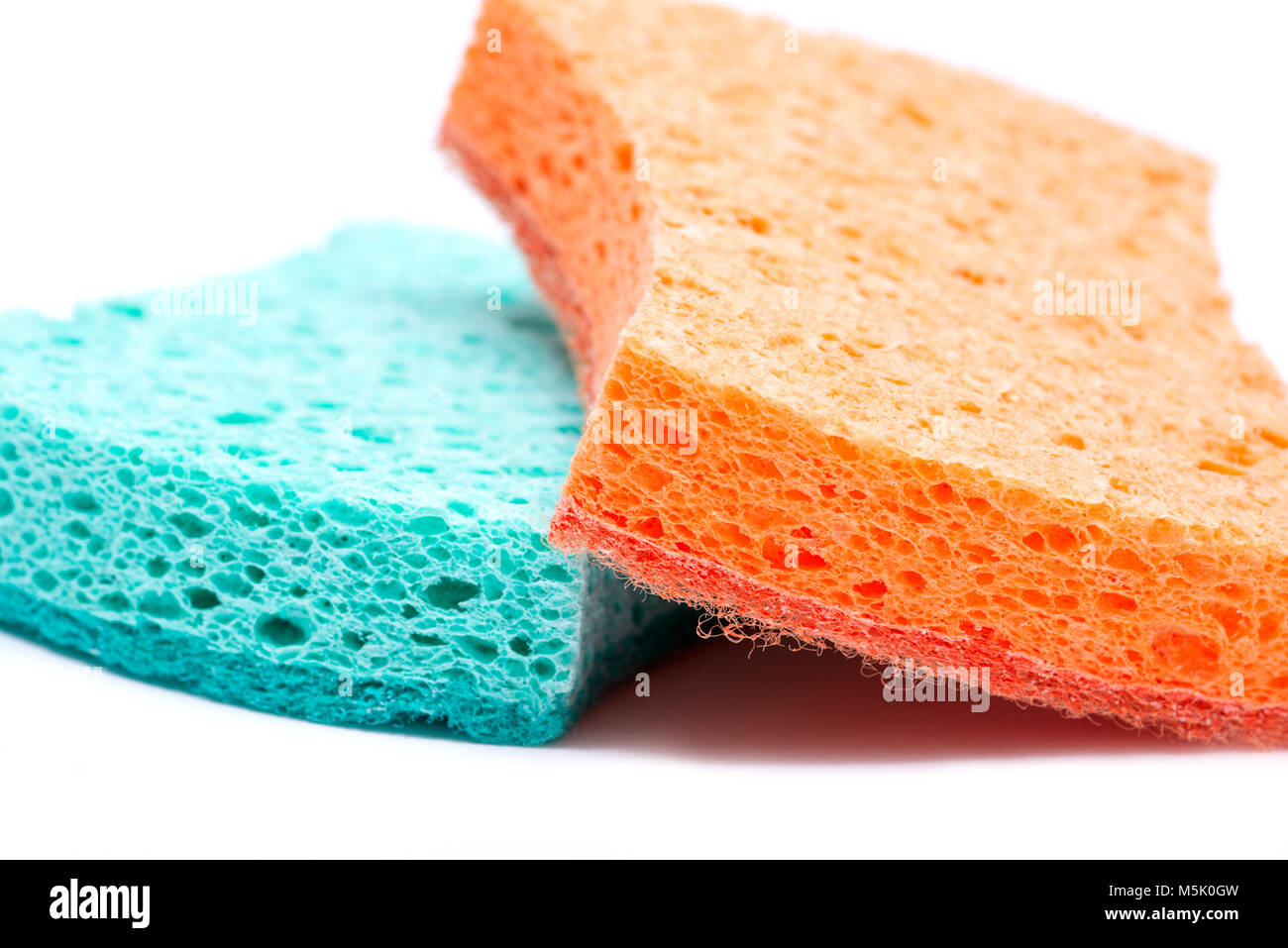 Orange and green non scratch scrubbing sponge isolated on white ...