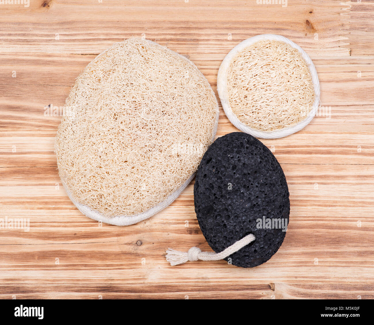 Real volcanic pumice stone and natural loofah sponge on wooden vintage ...