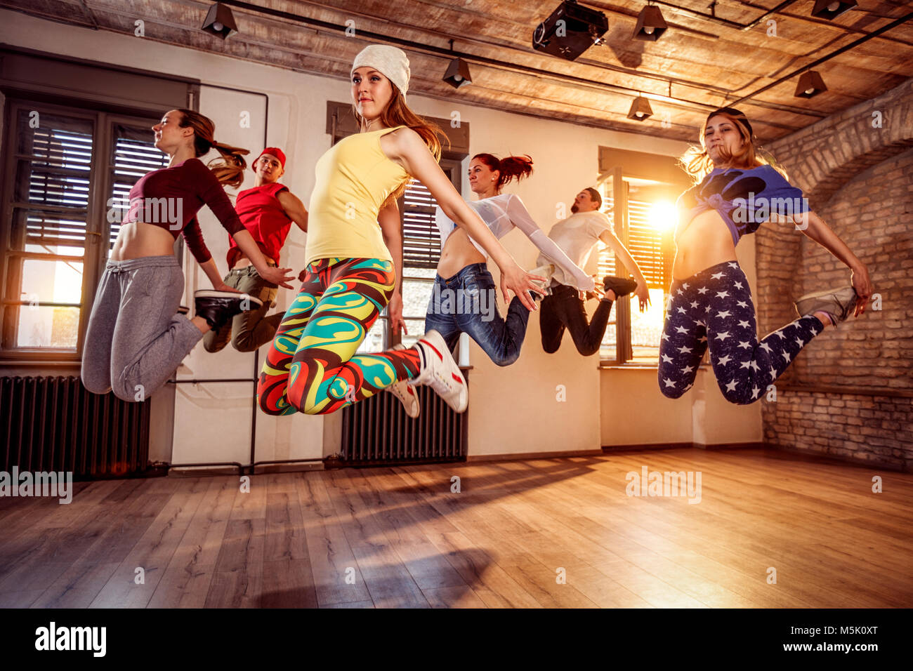 Group of young dancer people jumping during music Stock Photo - Alamy