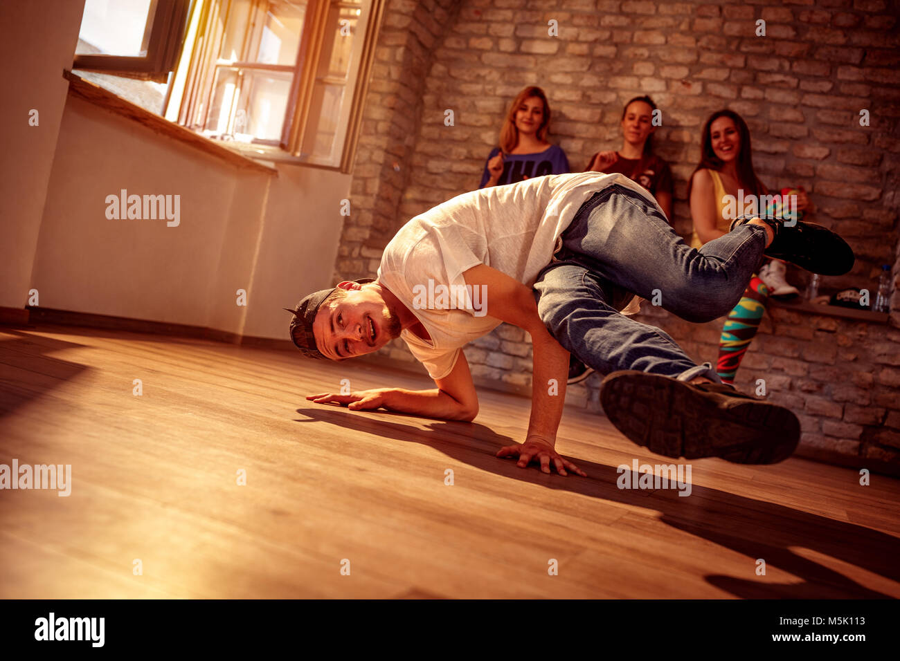 Young smiling hip hop men performs break dancing moves Stock Photo - Alamy