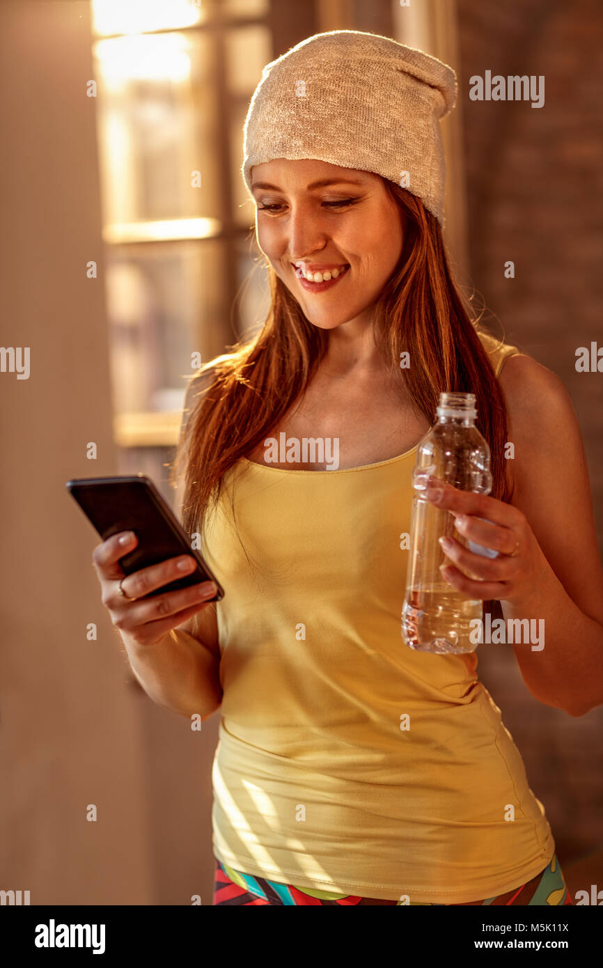 Smiling girl texting messaging on the smartphone Stock Photo - Alamy