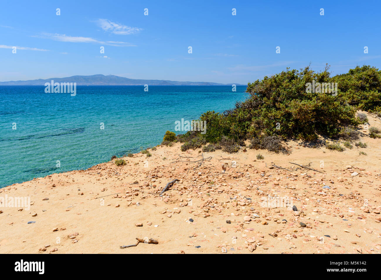 Green plants on cliff and view of crystal sea waters on Naxos island ...