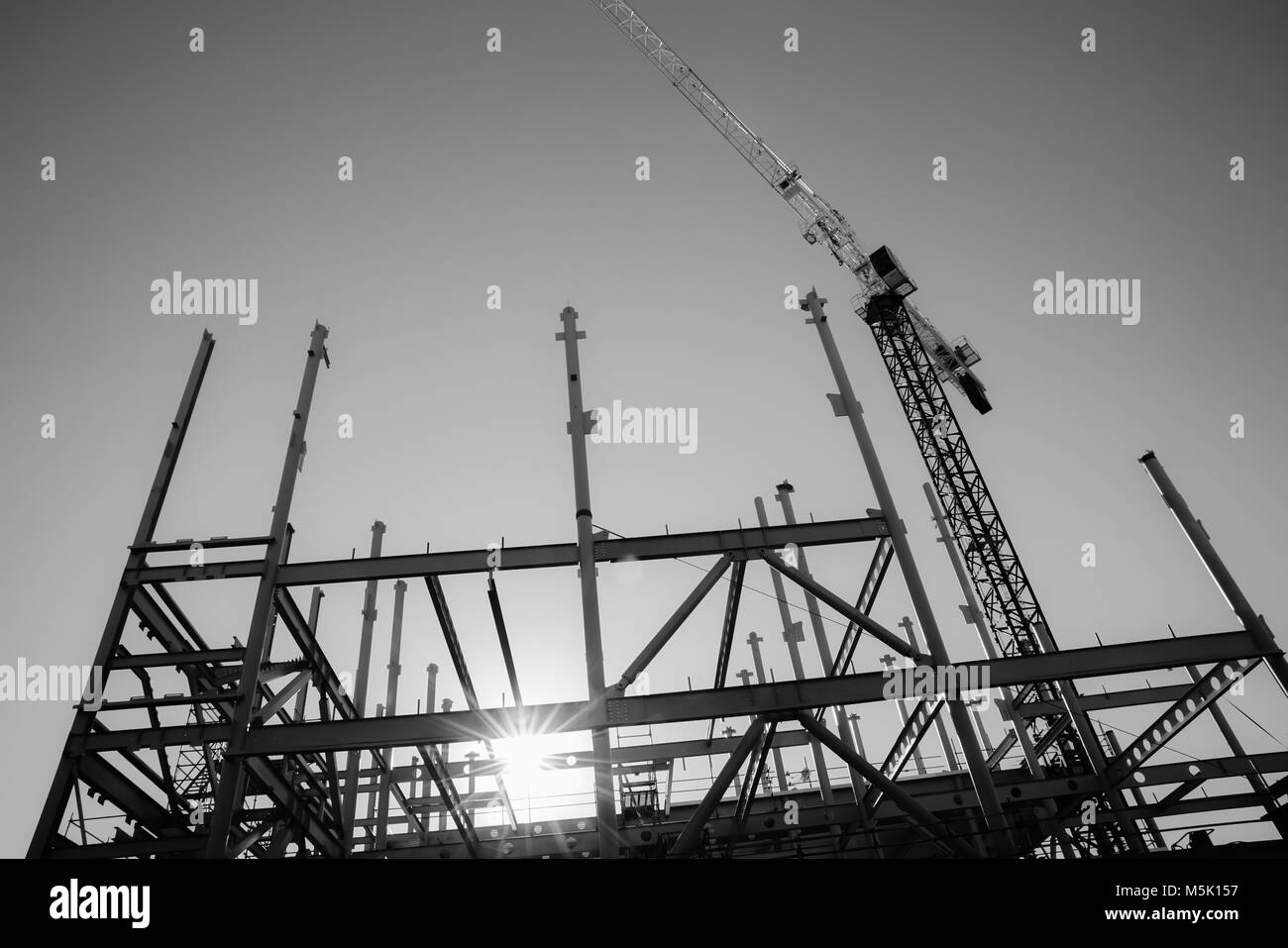 White structural steel framework for new building against deep sky in ...
