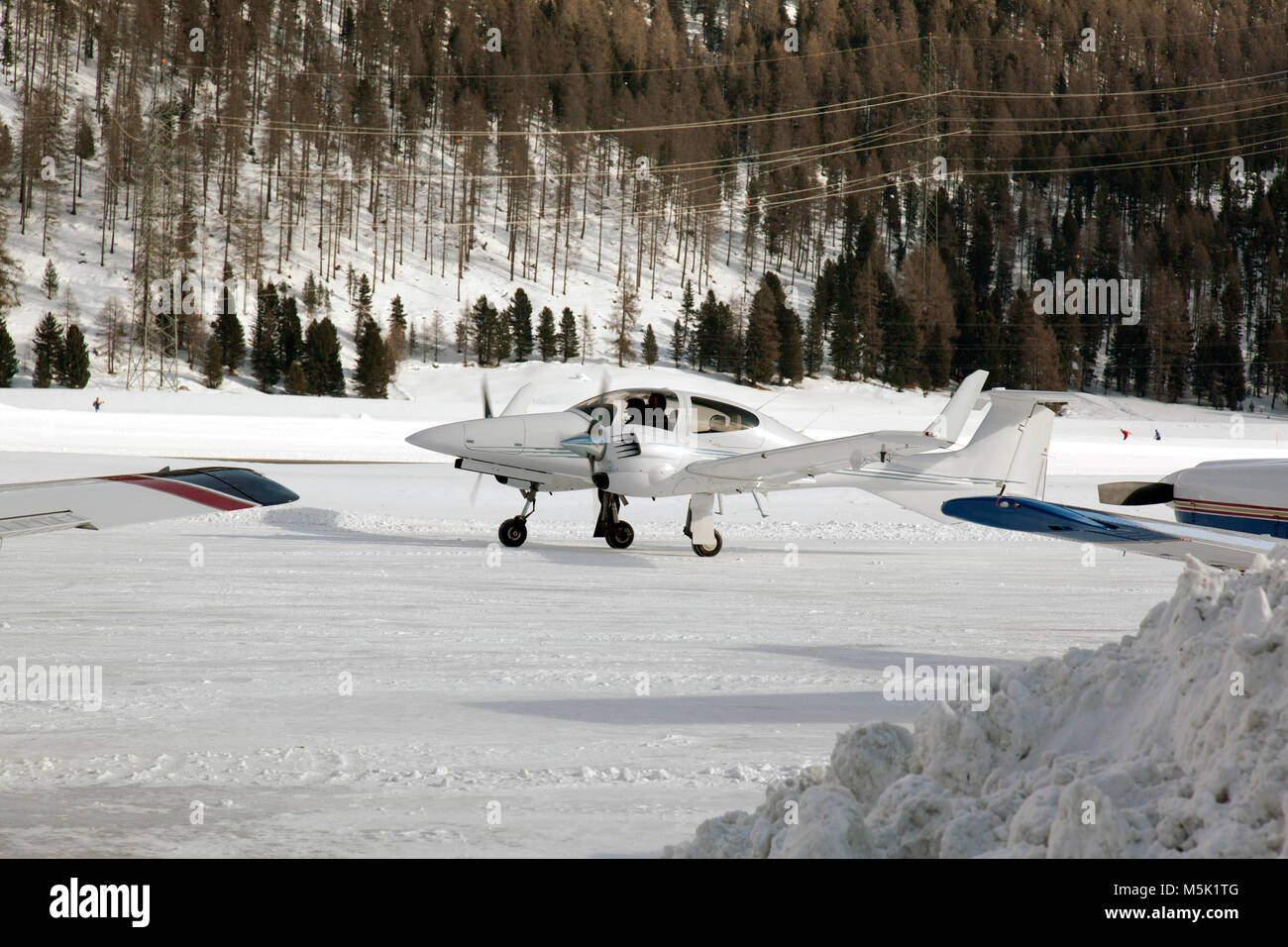 Private jets, airplanes and propeller type aircrafts in the snowy ...