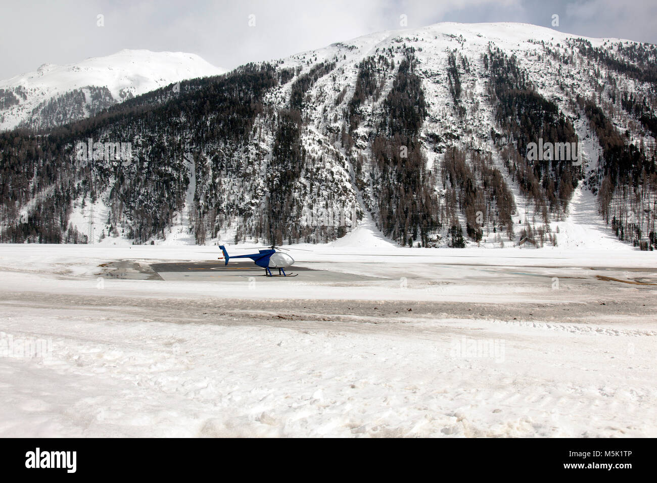 A covered helicopter in the beautiful snow covered landscape Stock ...