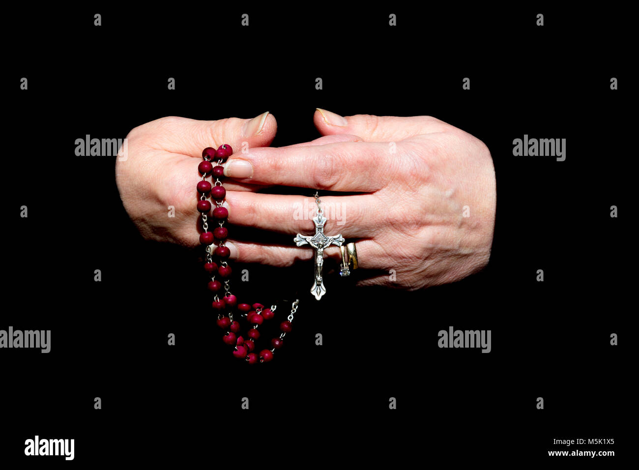 Female Hands Holding Rosary Beads. Isolated on Black Stock Photo - Alamy