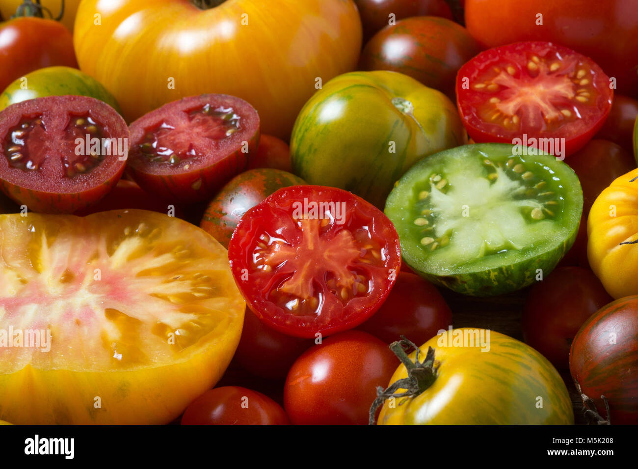 Close up of colourful tomatoes, some sliced, shot from above Stock ...