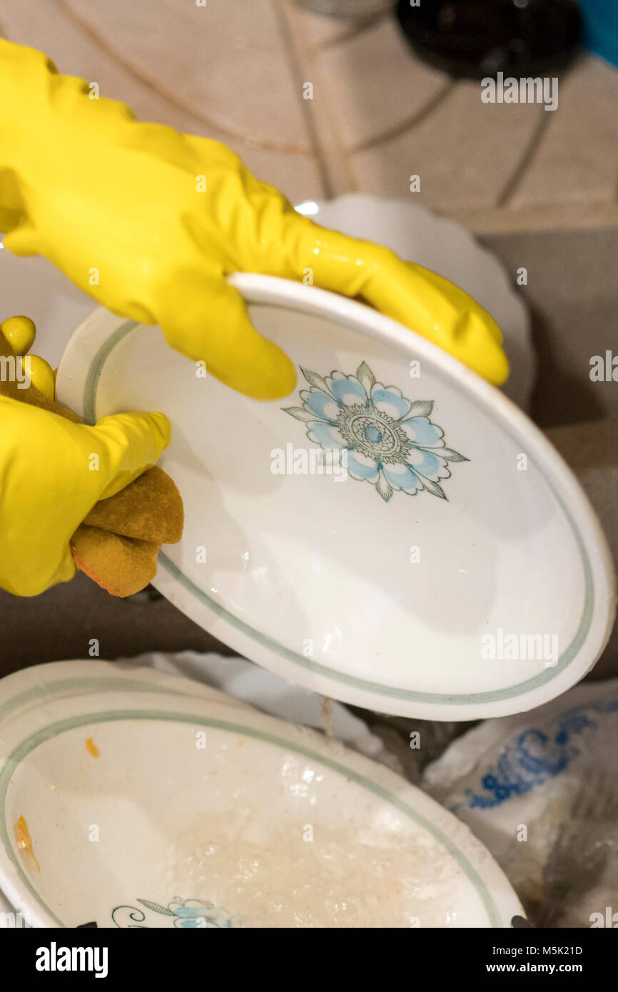 Woman's hands in the gloves wash plate horizontal closeup Stock Photo ...