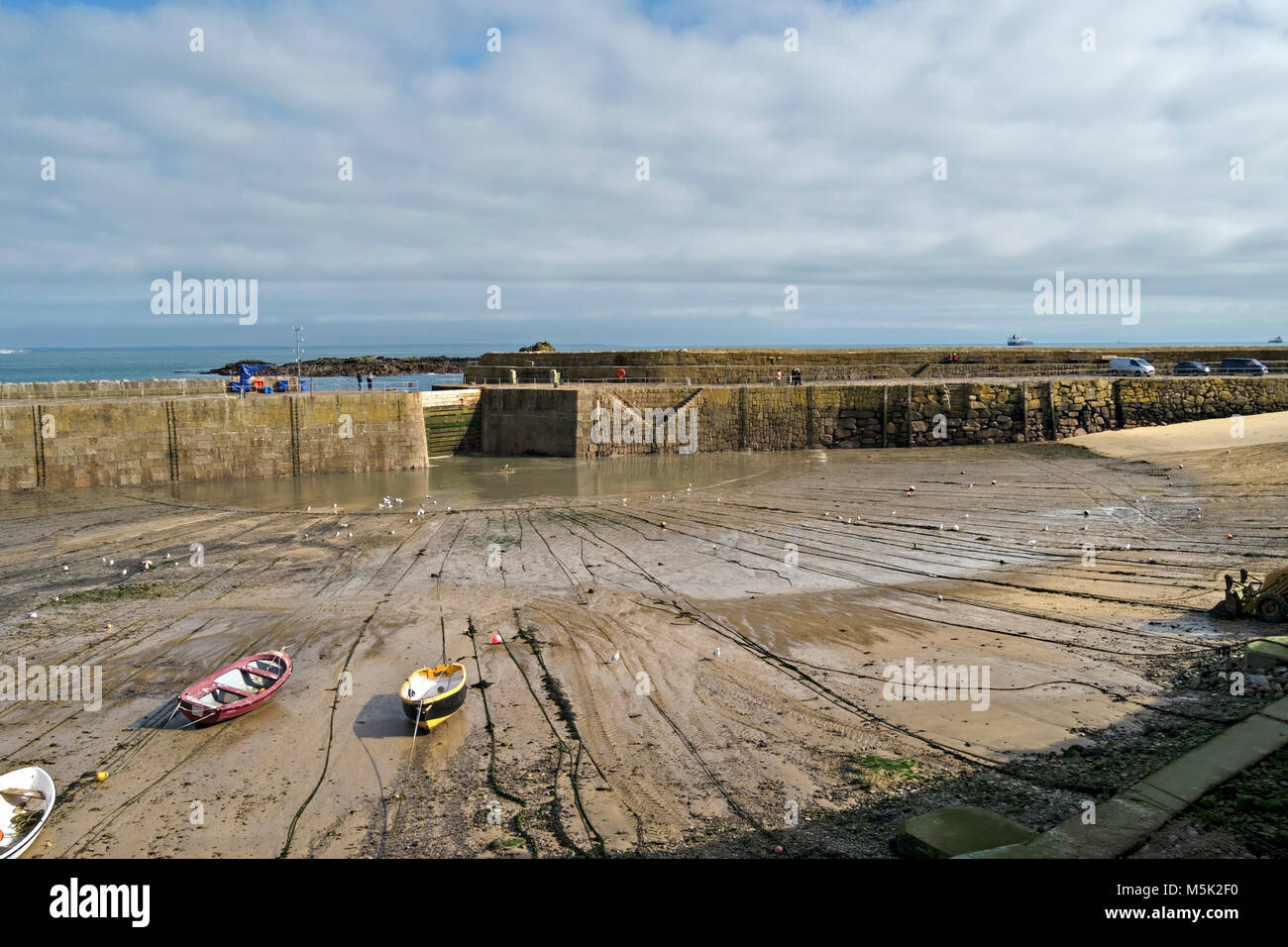 Mousehole harbour at low tide with entrance closed during winter for ...