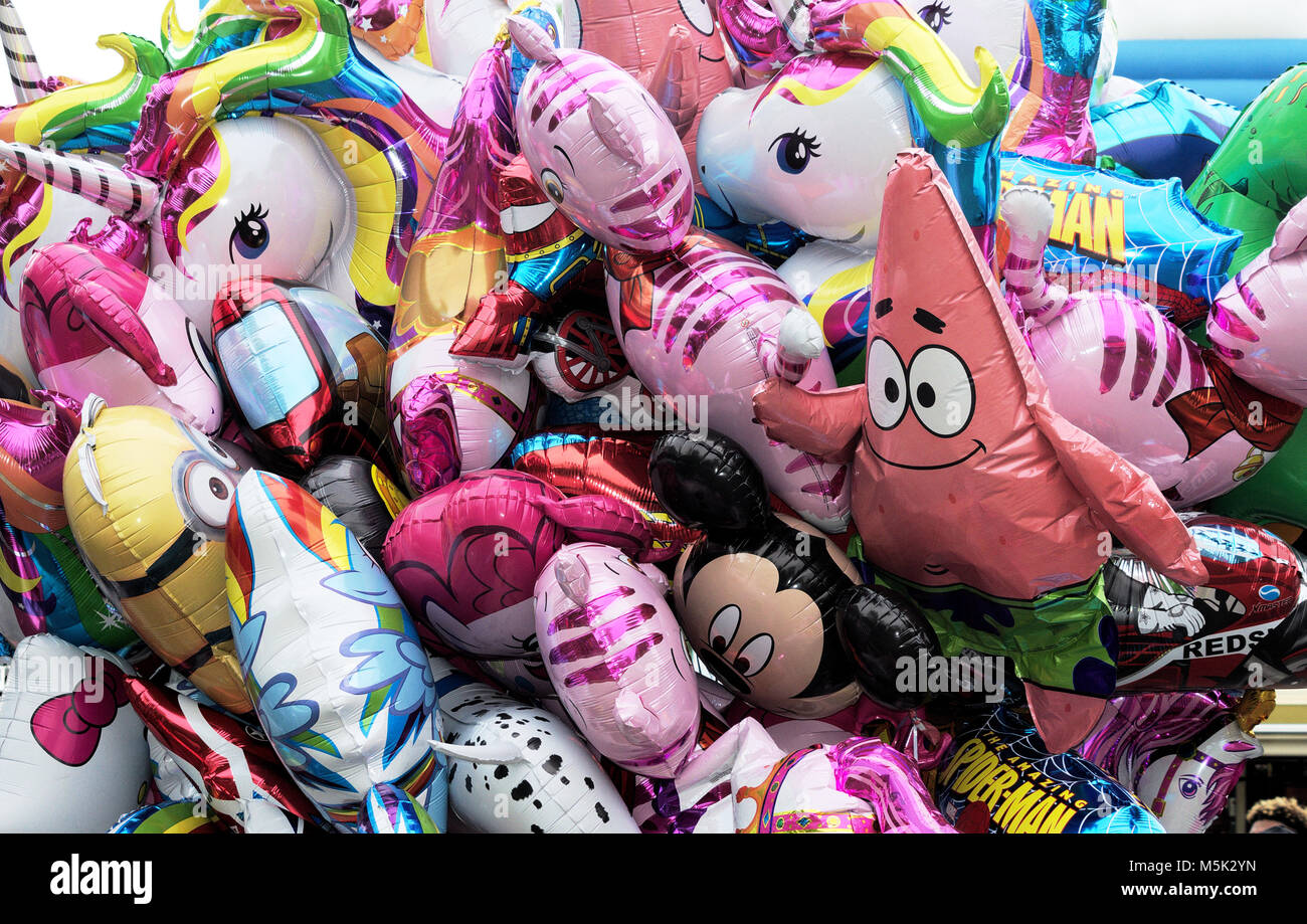Lots of ballons which are different shapes, colours and sizes floating ...