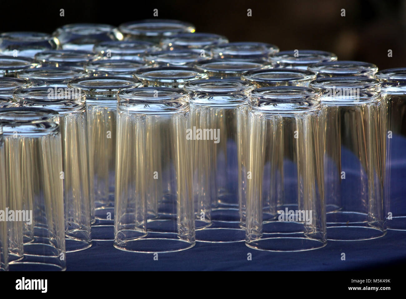 pile of empty transparent glasses on the table Stock Photo - Alamy